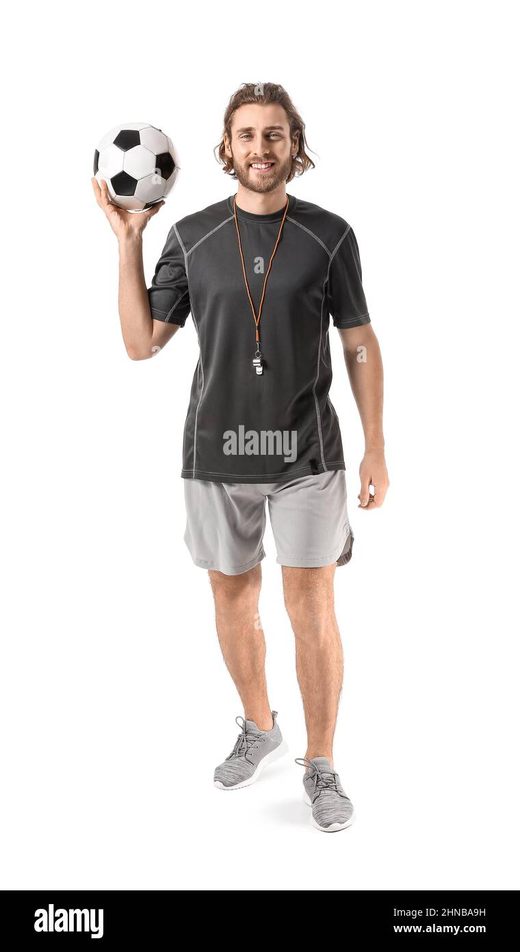 Sporty male coach with soccer ball on white background Stock Photo - Alamy
