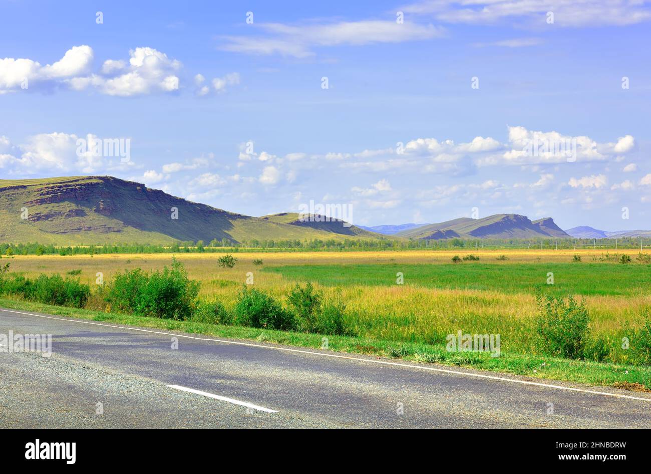Rocky cliffs in the steppe in summer under a blue cloudy sky. Siberia, Russia Stock Photo - Alamy