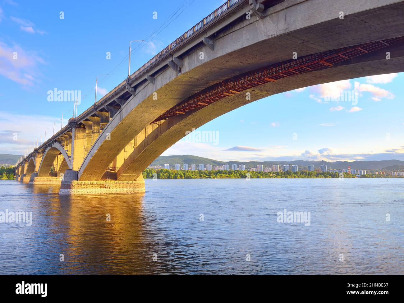 Arched bridge over the Yenisei River under a blue sky. Siberia, Russia ...