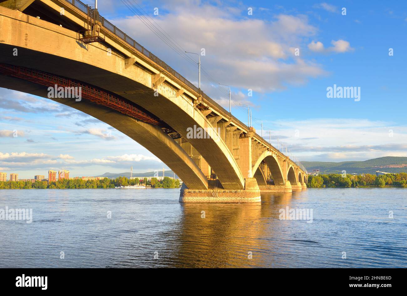 Arched bridge over the Yenisei River under a blue sky. Siberia, Russia ...