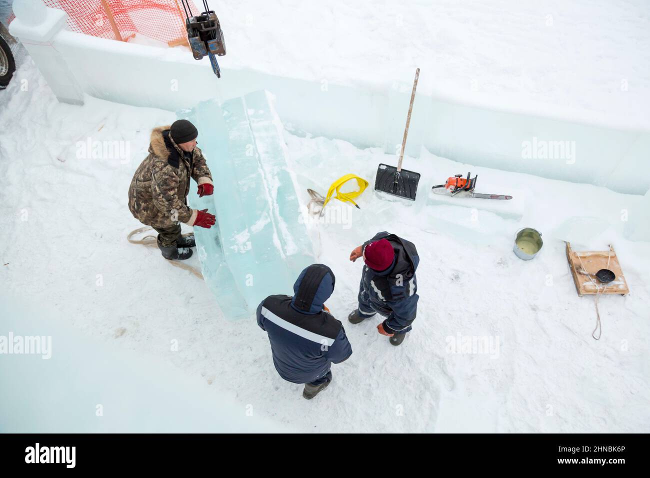 Slingers unload ice slabs with a truck crane Stock Photo - Alamy