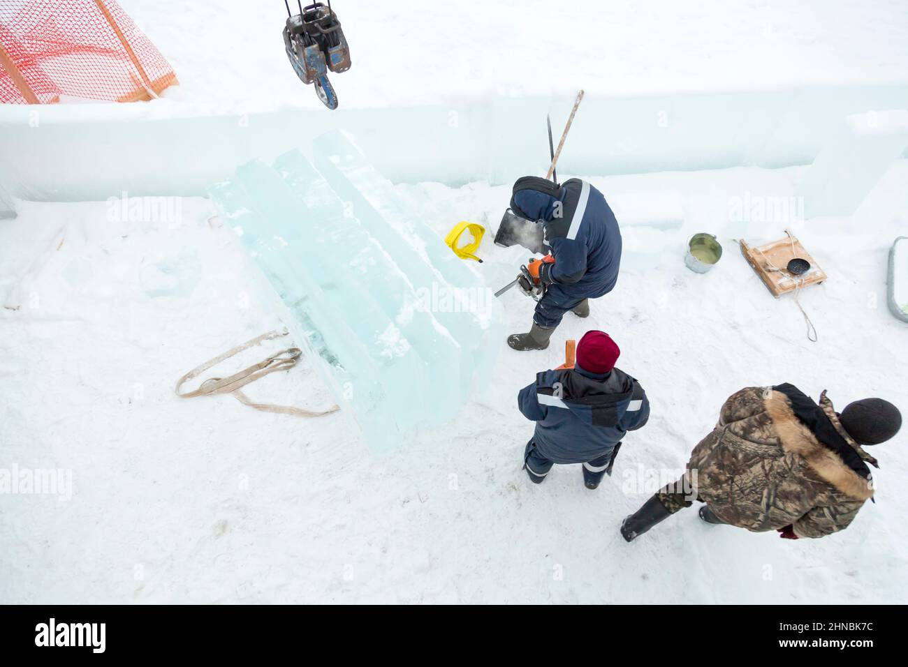 Slingers unload ice slabs with a truck crane Stock Photo - Alamy