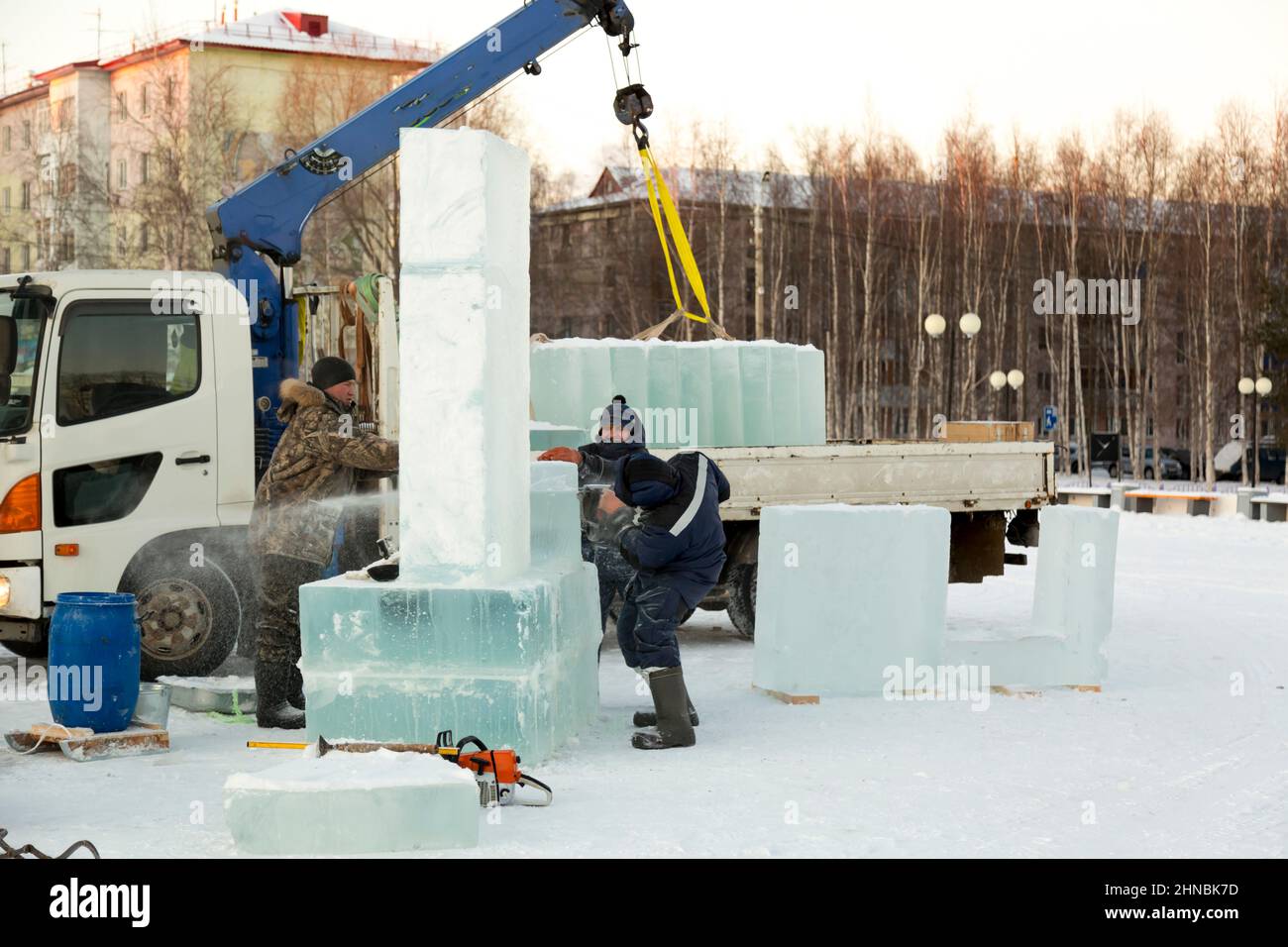 Slingers unload ice slabs with a truck crane Stock Photo - Alamy