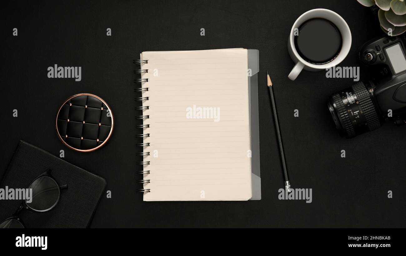 Top view, flat lay, Black workspace background with camera, equipment ...