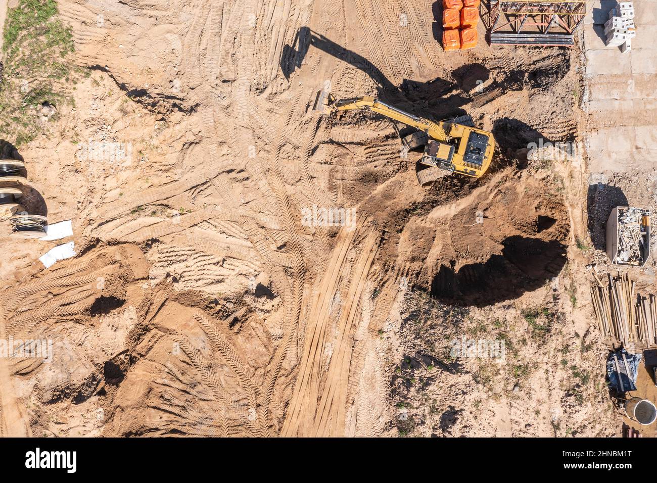 aerial top view of industrial excavator working on construction site ...
