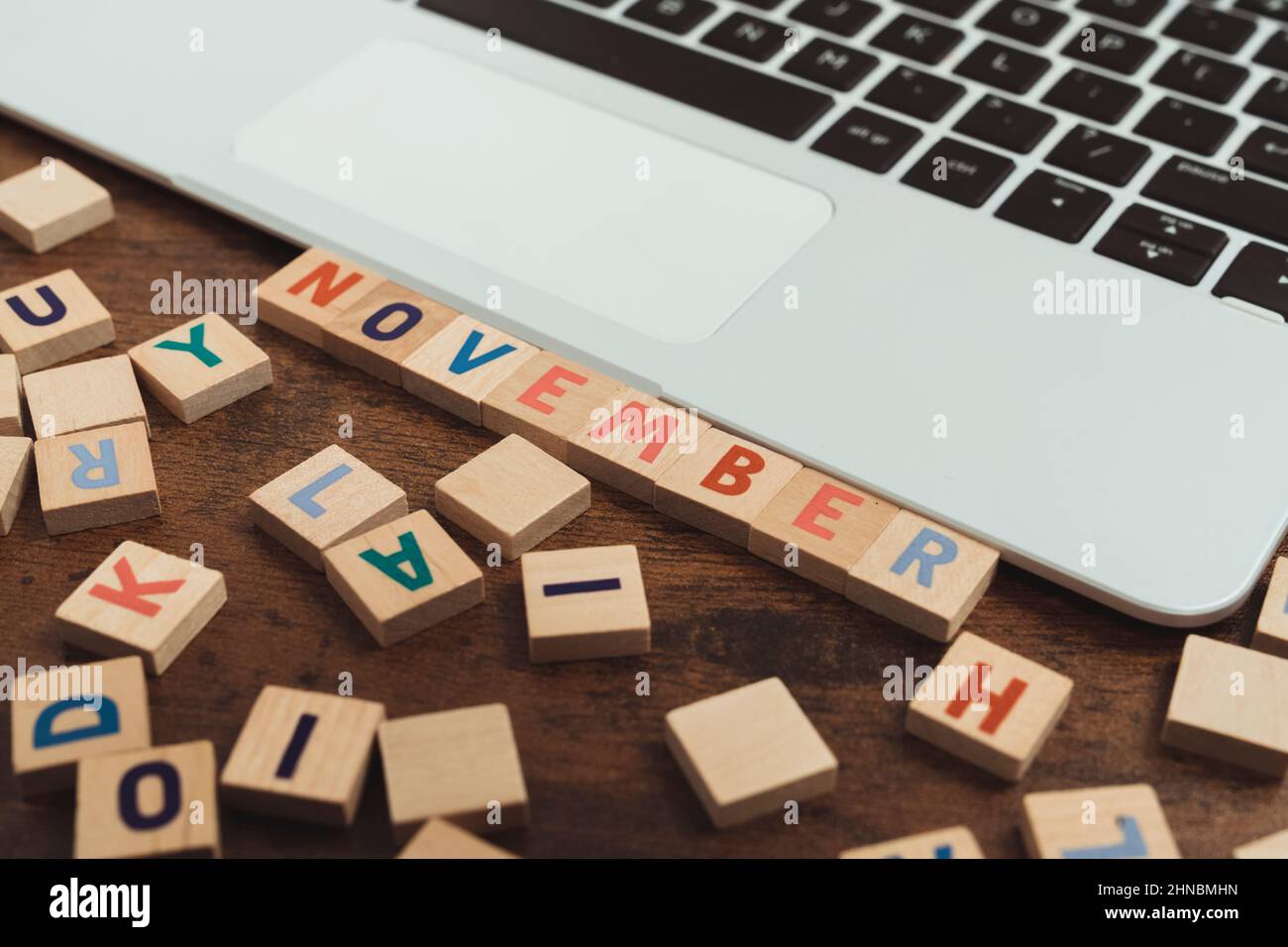 The name of the month November written on wooden cubes od the tabletop ...