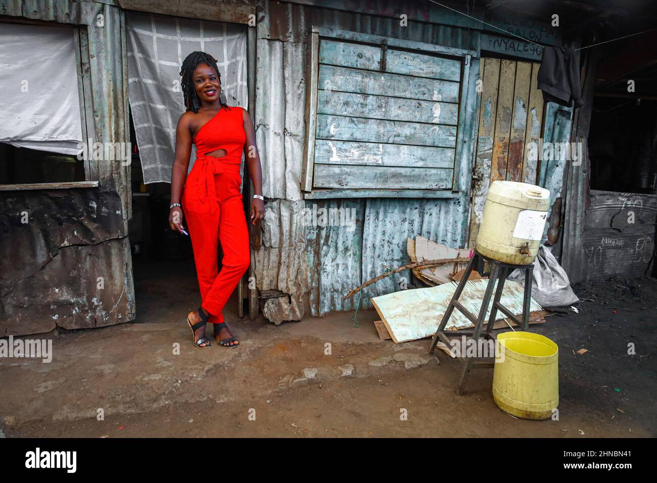 A lady dressed in a red poses by the streets on Valentines day in ...