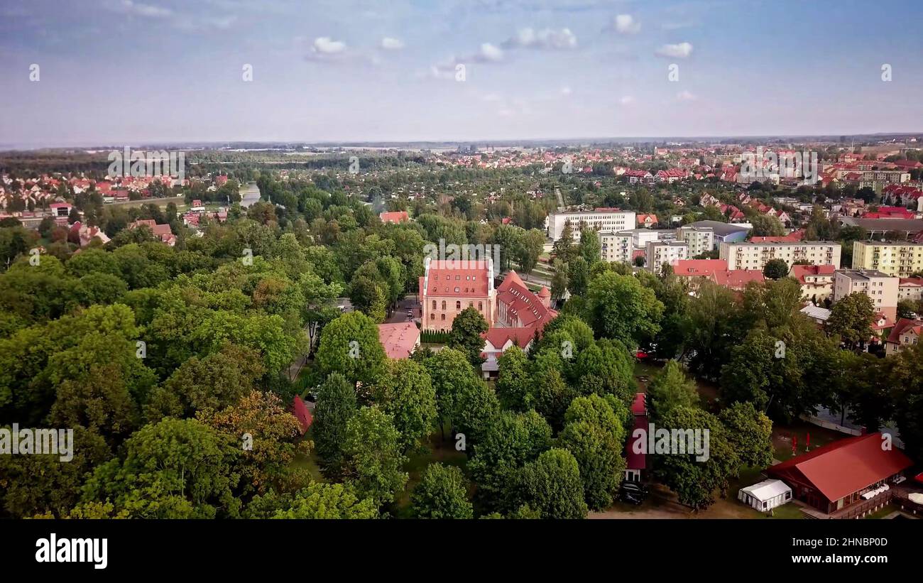 Aerial view of a town with red roofs and surrounded by trees with a ...