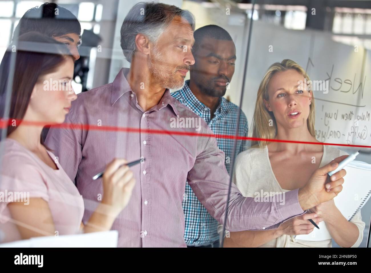 Clearly communicating his ideas. A group of business colleagues ...