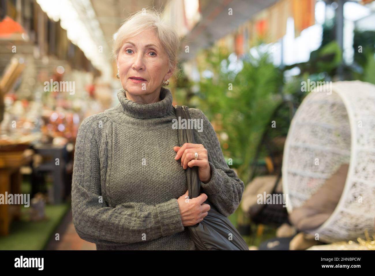 Senior woman shopping in home goods store Stock Photo - Alamy