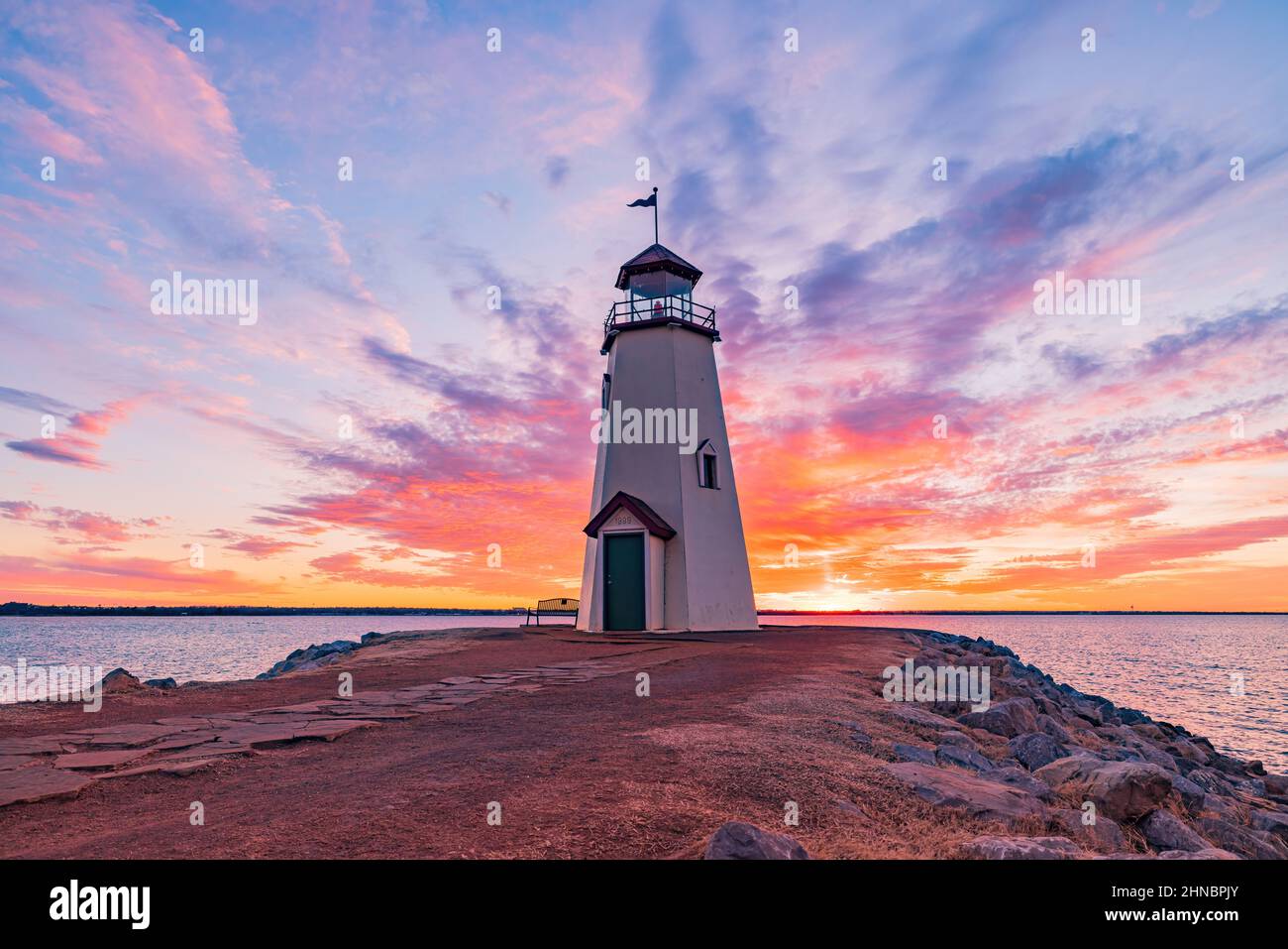 Sunset beautiful afterglow over the lighthouse of Lake Hefner at ...