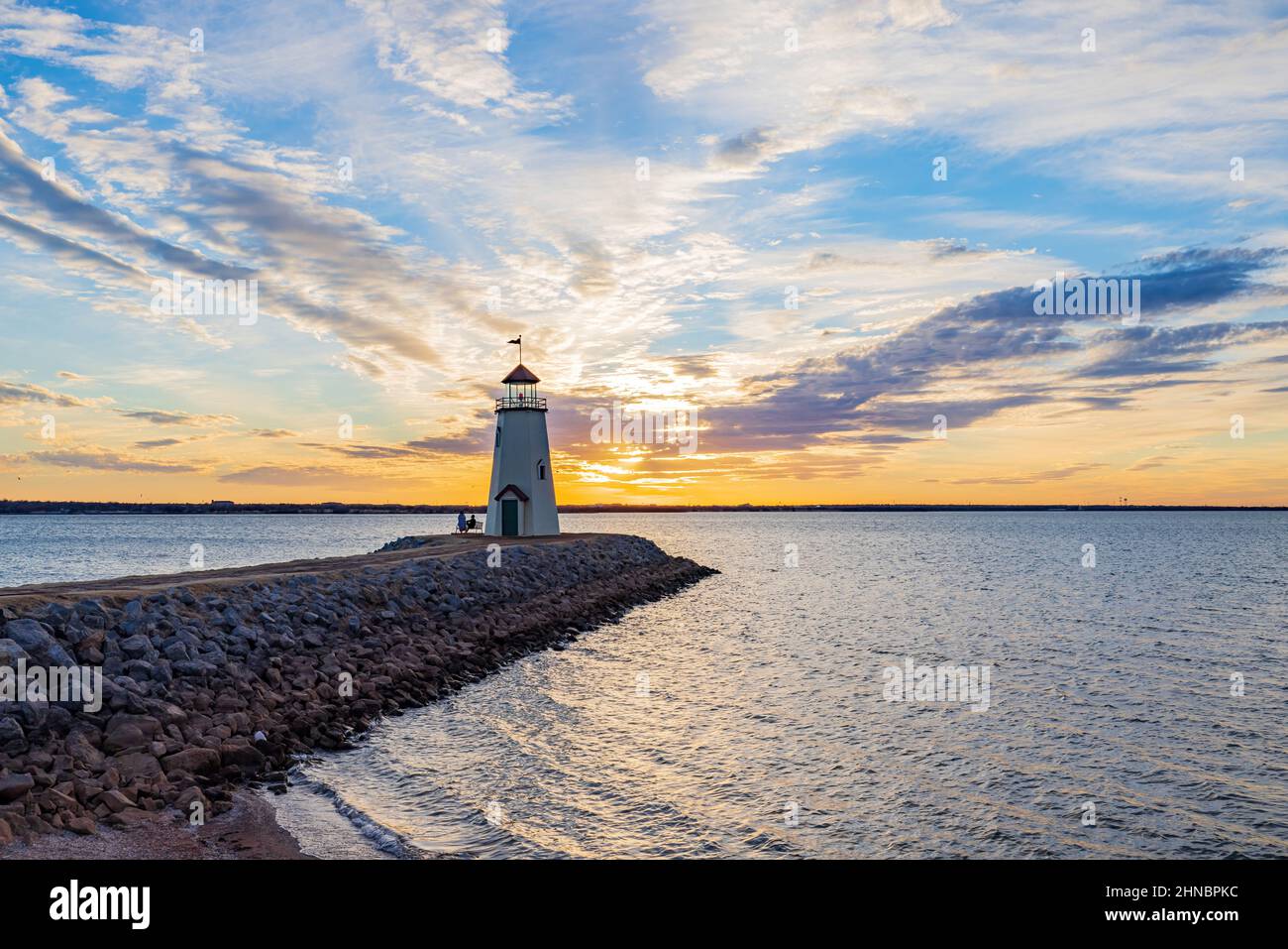 Sunset beautiful afterglow over the lighthouse of Lake Hefner at ...