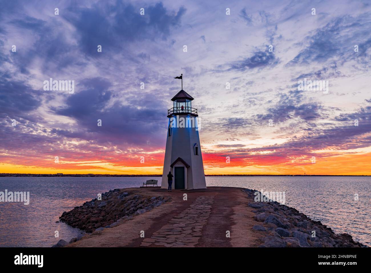Sunset beautiful afterglow over the lighthouse of Lake Hefner at ...