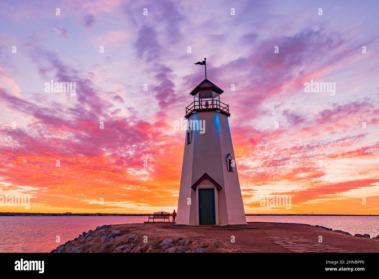 Sunset beautiful afterglow over the lighthouse of Lake Hefner at ...