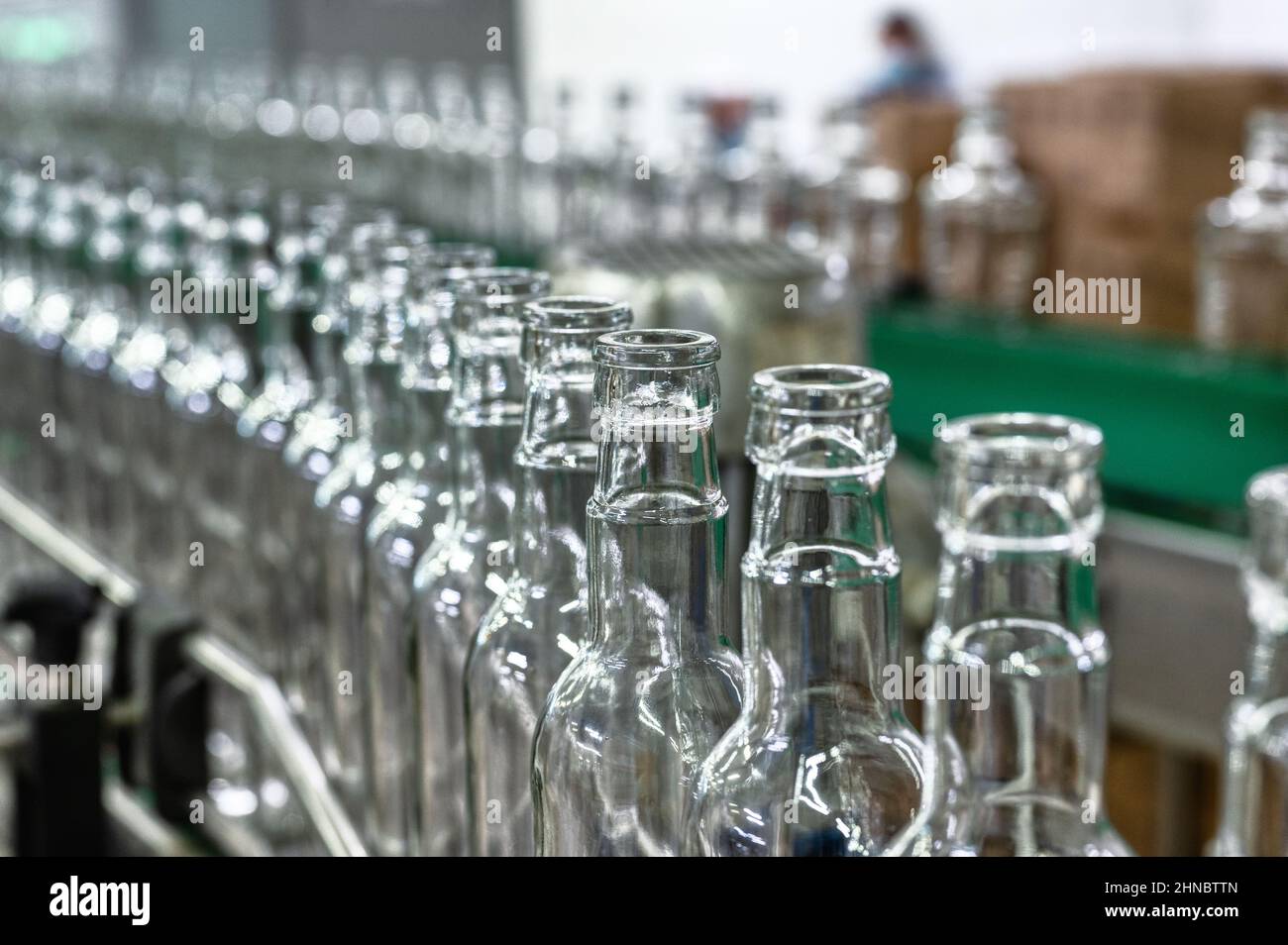 Conveyor belt carries clean glass bottles for alcohol drinks Stock ...