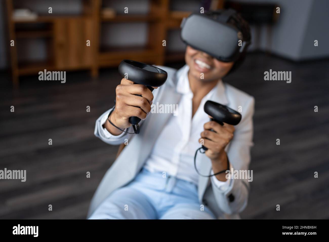 Happy african woman office employee playing VR games, enjoying gaming ...
