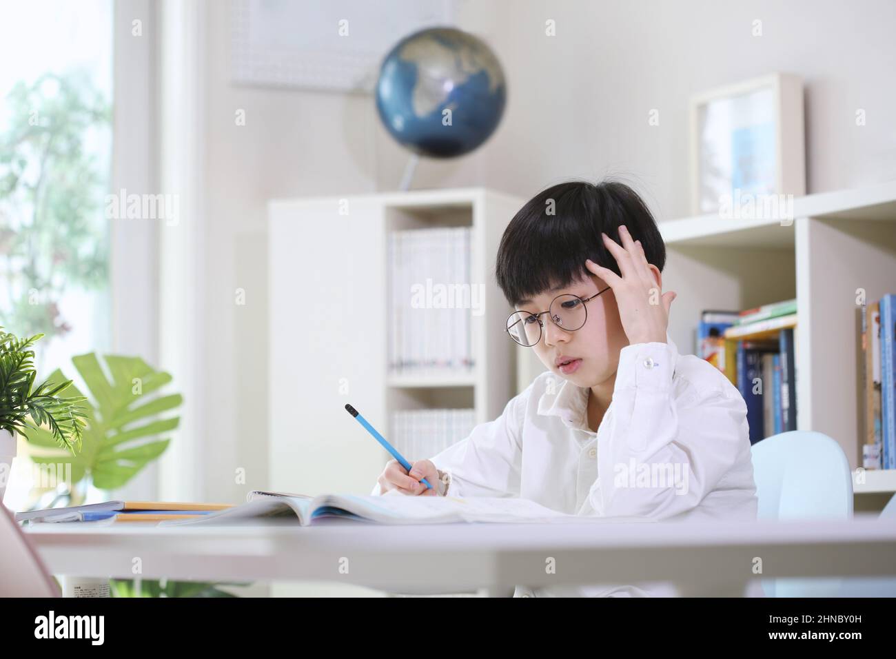 Smart and cute student thinking carefully, concentrating and studying ...