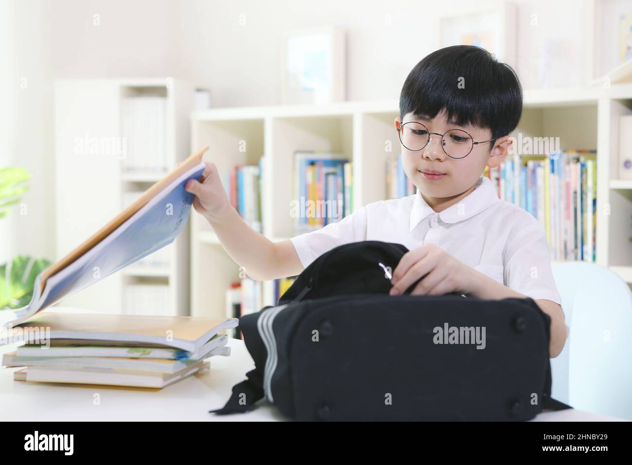 A student preparing to go to school with a backpack or a student ...