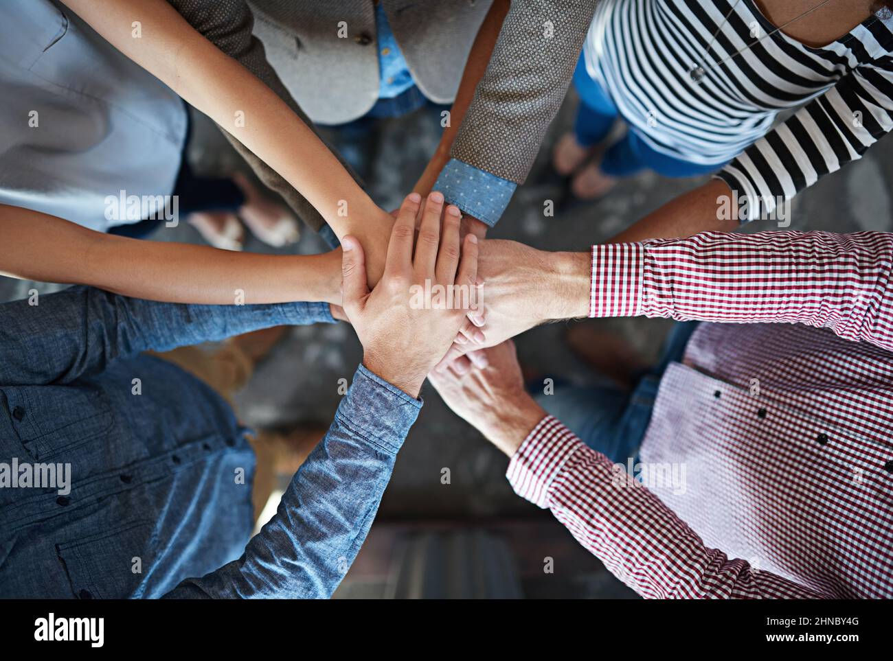 Team can-do. Top view of co-workers hand put together in an expression of unity and team spirit ...