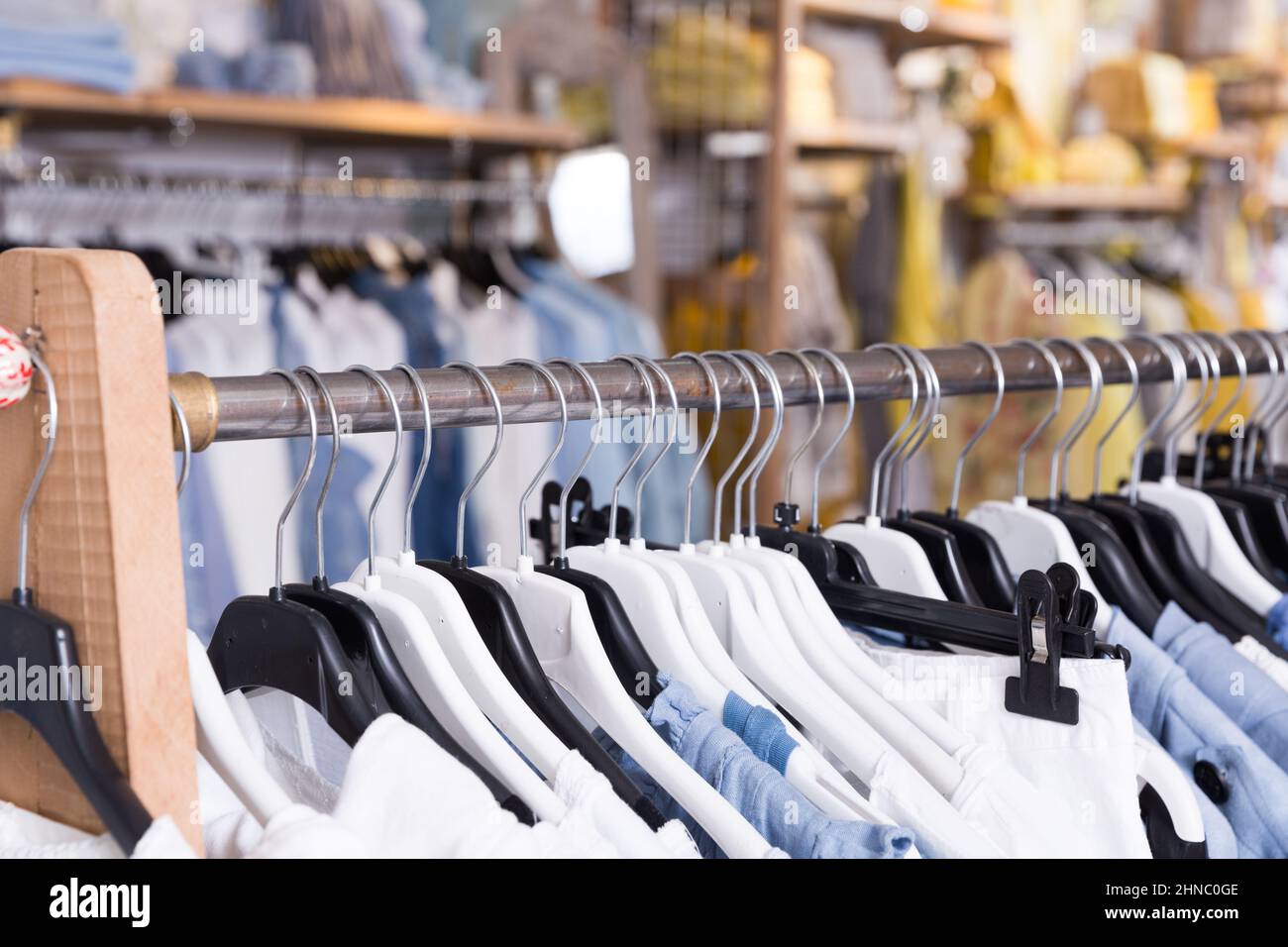 Colorful clothes hanging on hangers in the fashion store Stock Photo ...