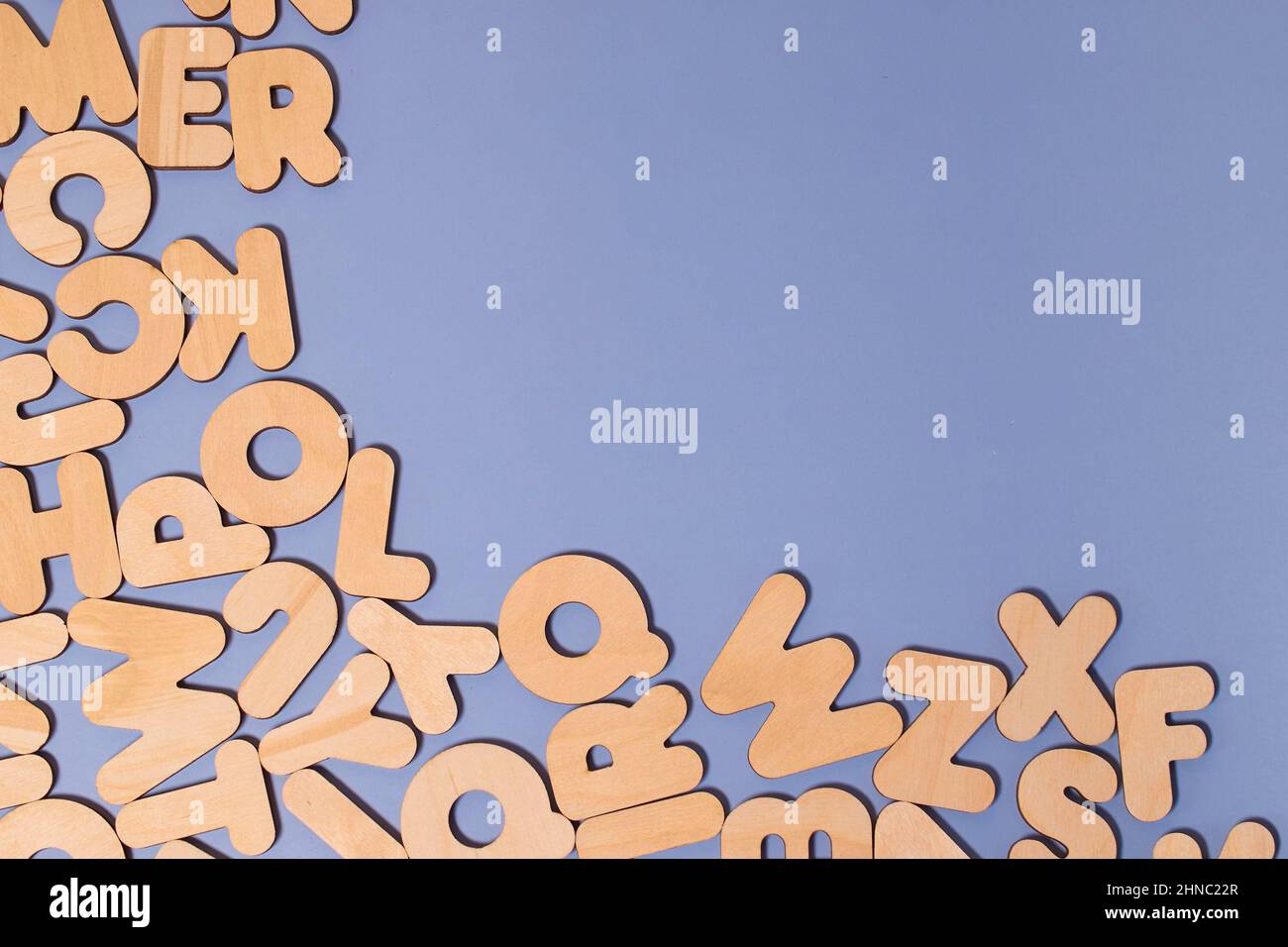 A set of wooden letters of the English alphabet on a colored background ...