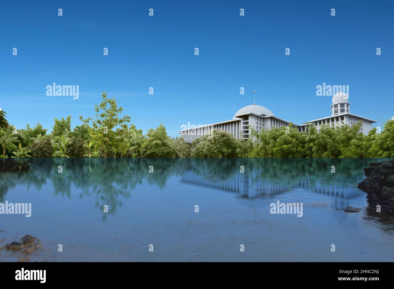 Mosque with pond and trees with the blue sky background. Jakarta ...