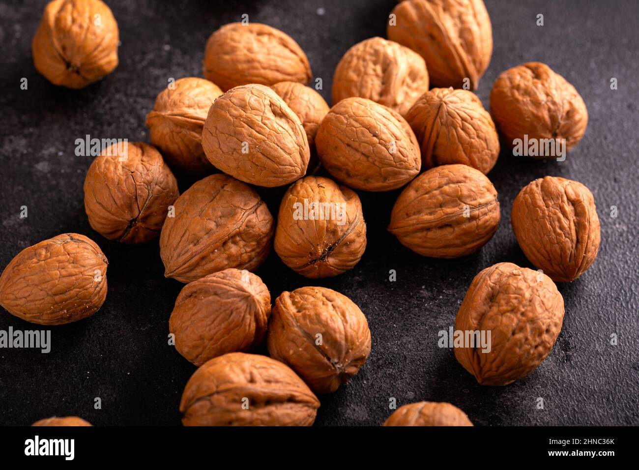 raw walnut in shell on old rustic background Stock Photo - Alamy