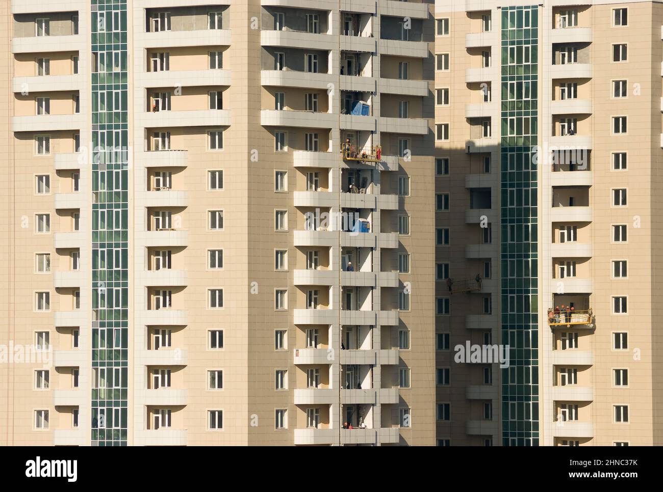 Exterior finishing work on the construction of high-rise residential ...