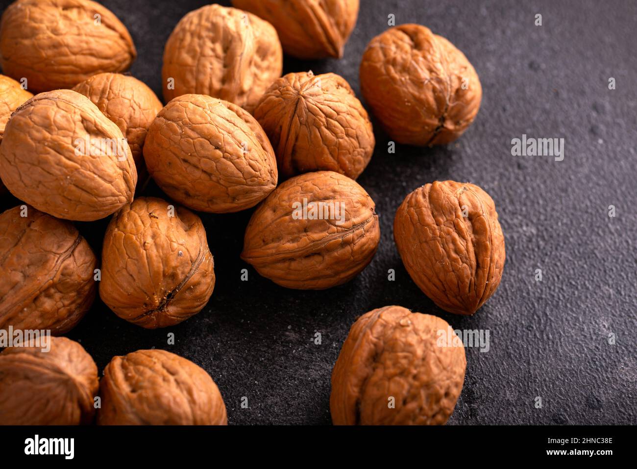 raw walnut in shell on old rustic background Stock Photo - Alamy