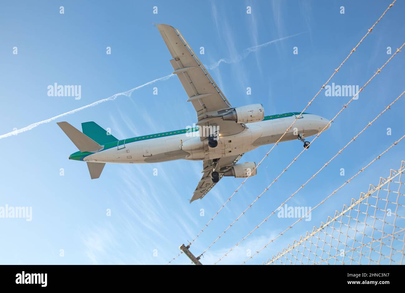 Large airplane preparing the landing with a blue sky Stock Photo - Alamy