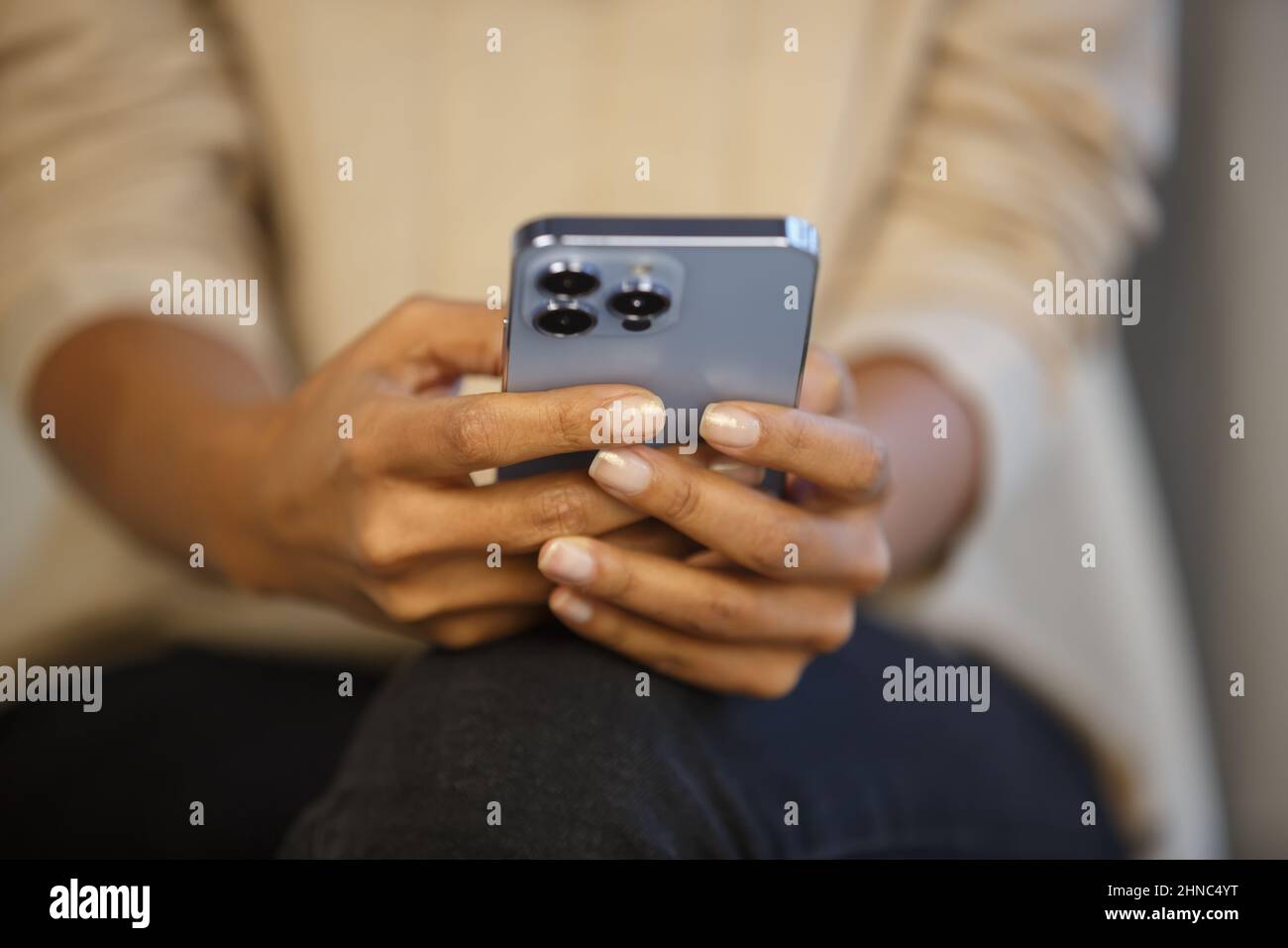 Young black woman texting in messenger app on smartphone. African ...