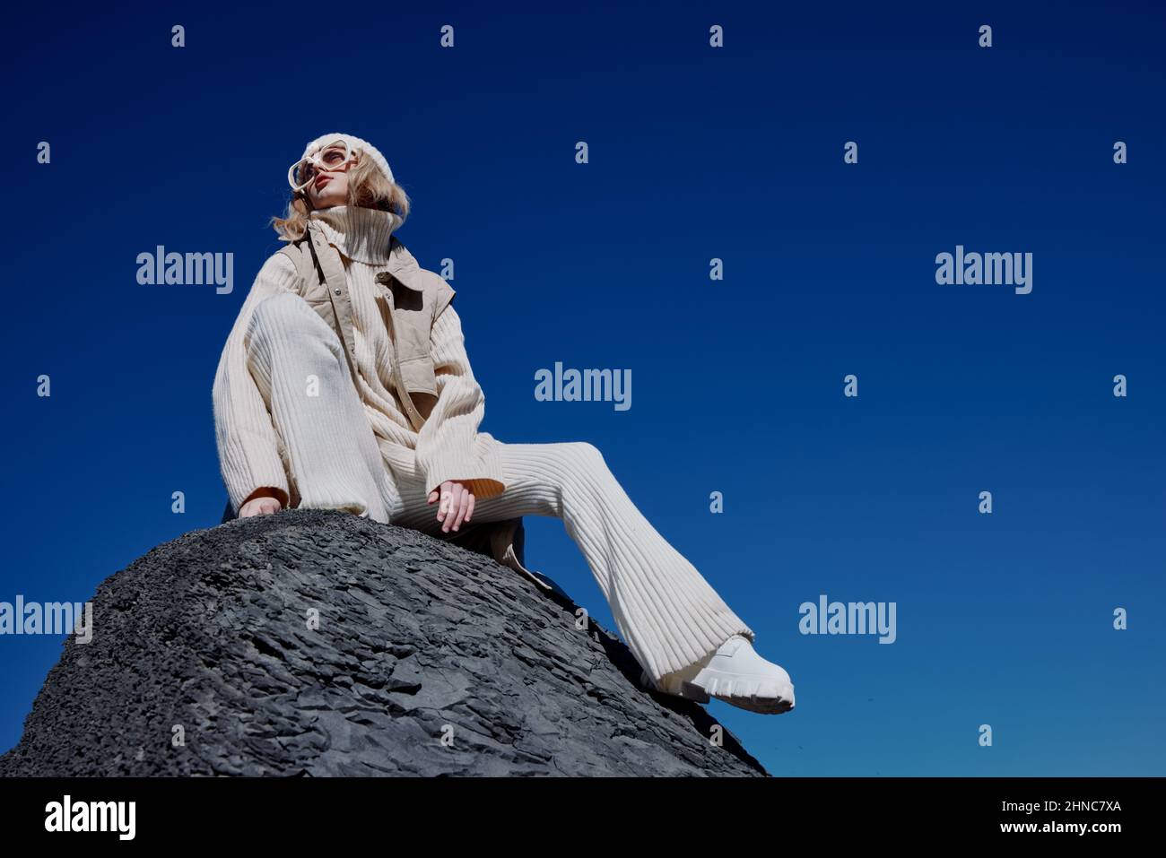 Woman sitting stone mountainscape hi-res stock photography and images ...