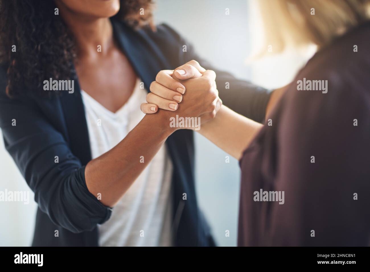 Hand in hand in the journey of success. Cropped shot of two ...