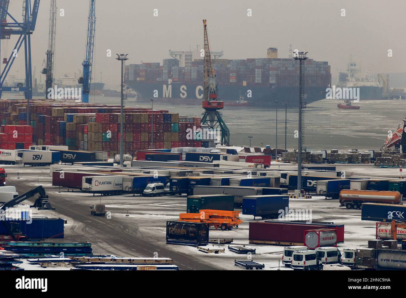 Closeup of a container ship proceeding and mooring at container ...