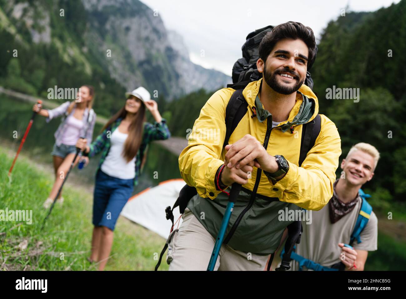 Group of friends hiking together outdoors exploring the wilderness and ...