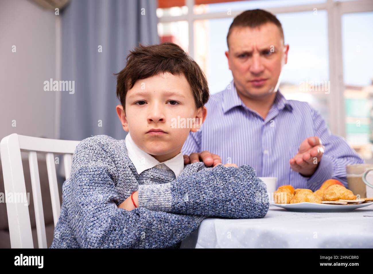 Upset father and offended son arguing in domestic interior Stock Photo ...