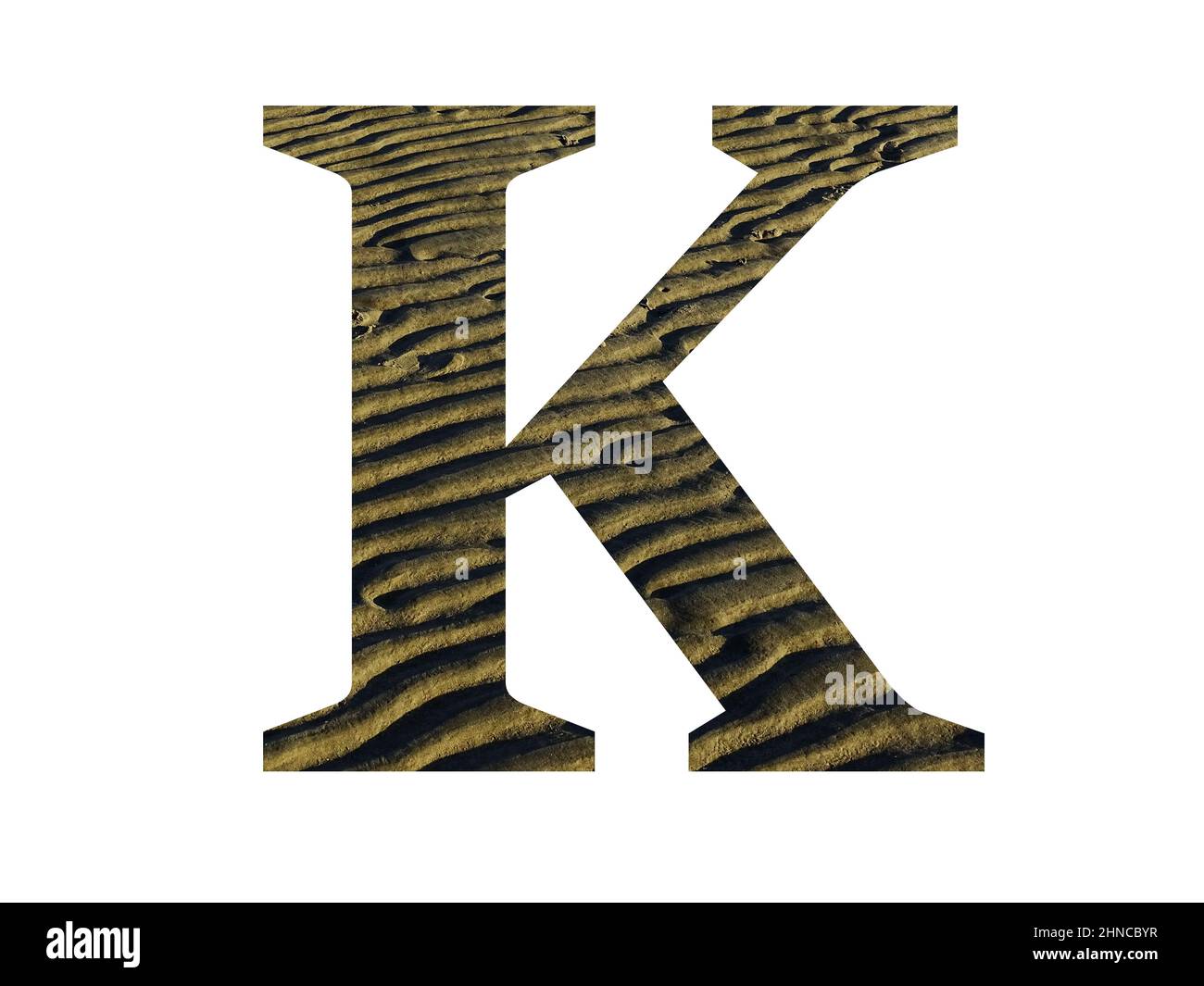 letter K of the alphabet made with ridges from the beach, color yellow ...