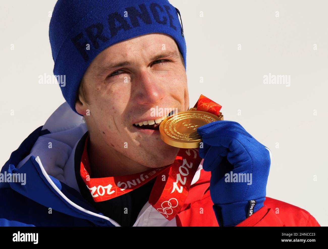 Beijing, China. 16th Feb, 2022. Clement Noel of France bites his gold ...
