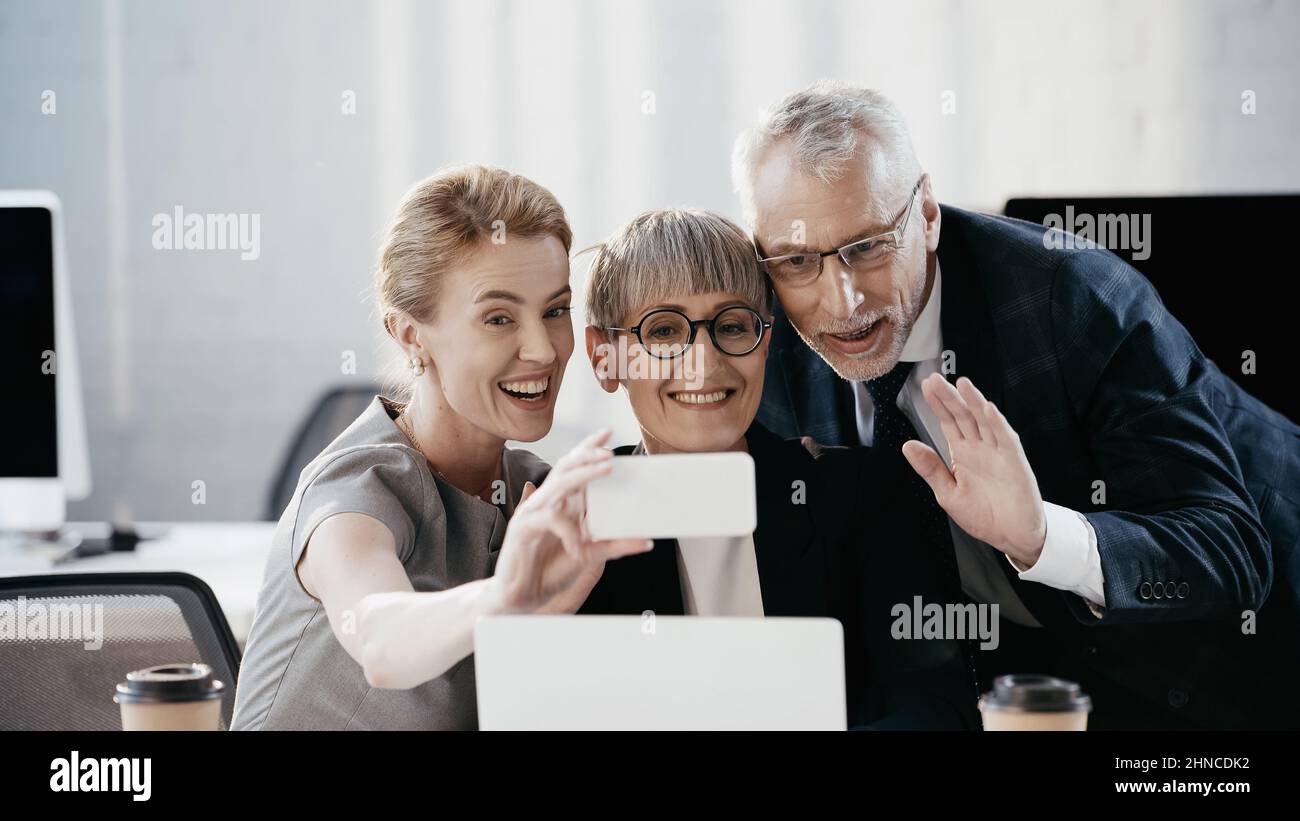 Smiling business people having video call on smartphone in office Stock ...