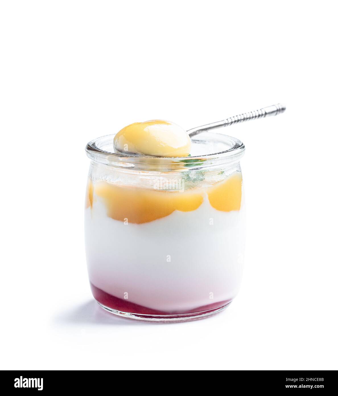 White creamy yogurt with yellow fruitty puree in small jar isolated on ...