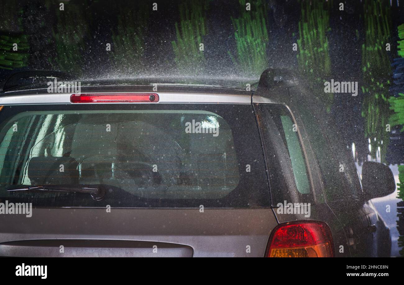 Grey car during washing process Stock Photo - Alamy