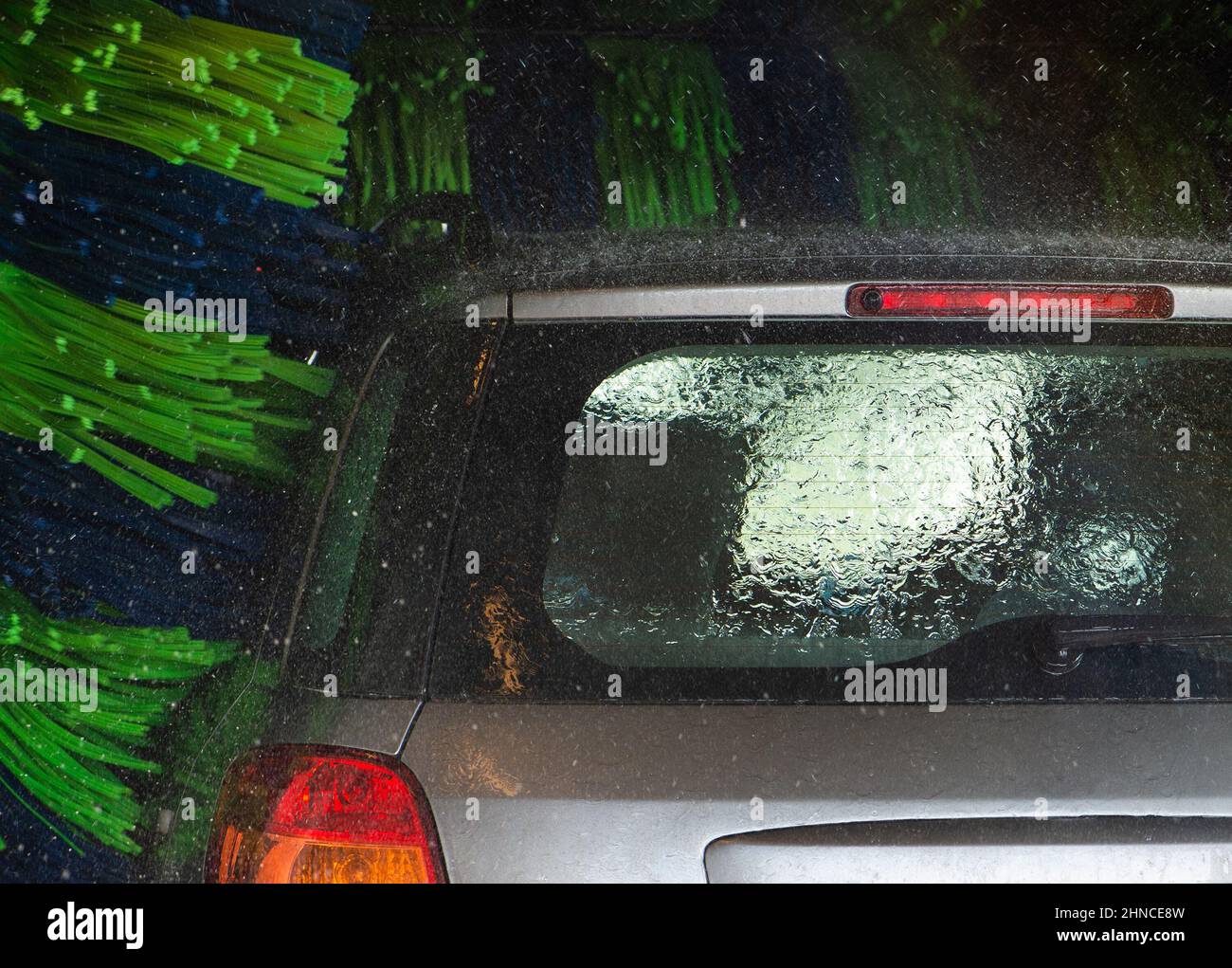 Grey car during washing process Stock Photo - Alamy