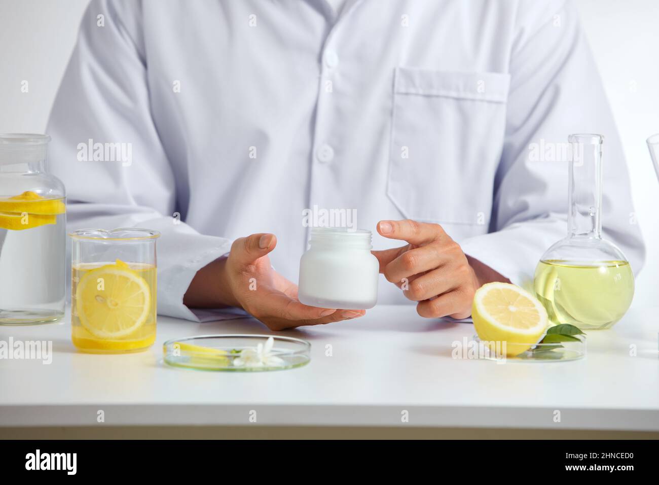 Lemon extract with sliced lemon transparent podium in laboratory ...
