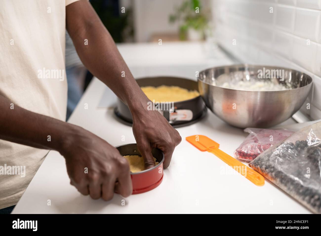 African guy making shortbread pastry for pie. Cooking process of ...