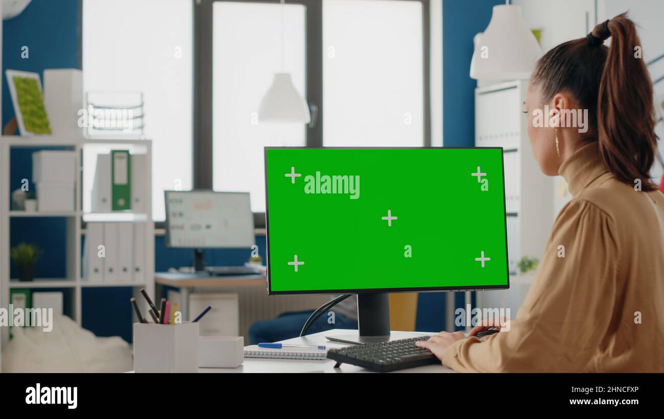 Adult using green screen on computer display in business office. Woman ...