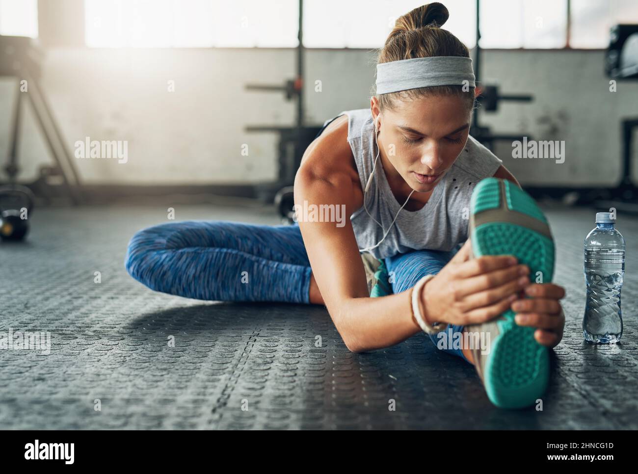 Stretching those legs to perfection. Shot of a young attractive woman ...