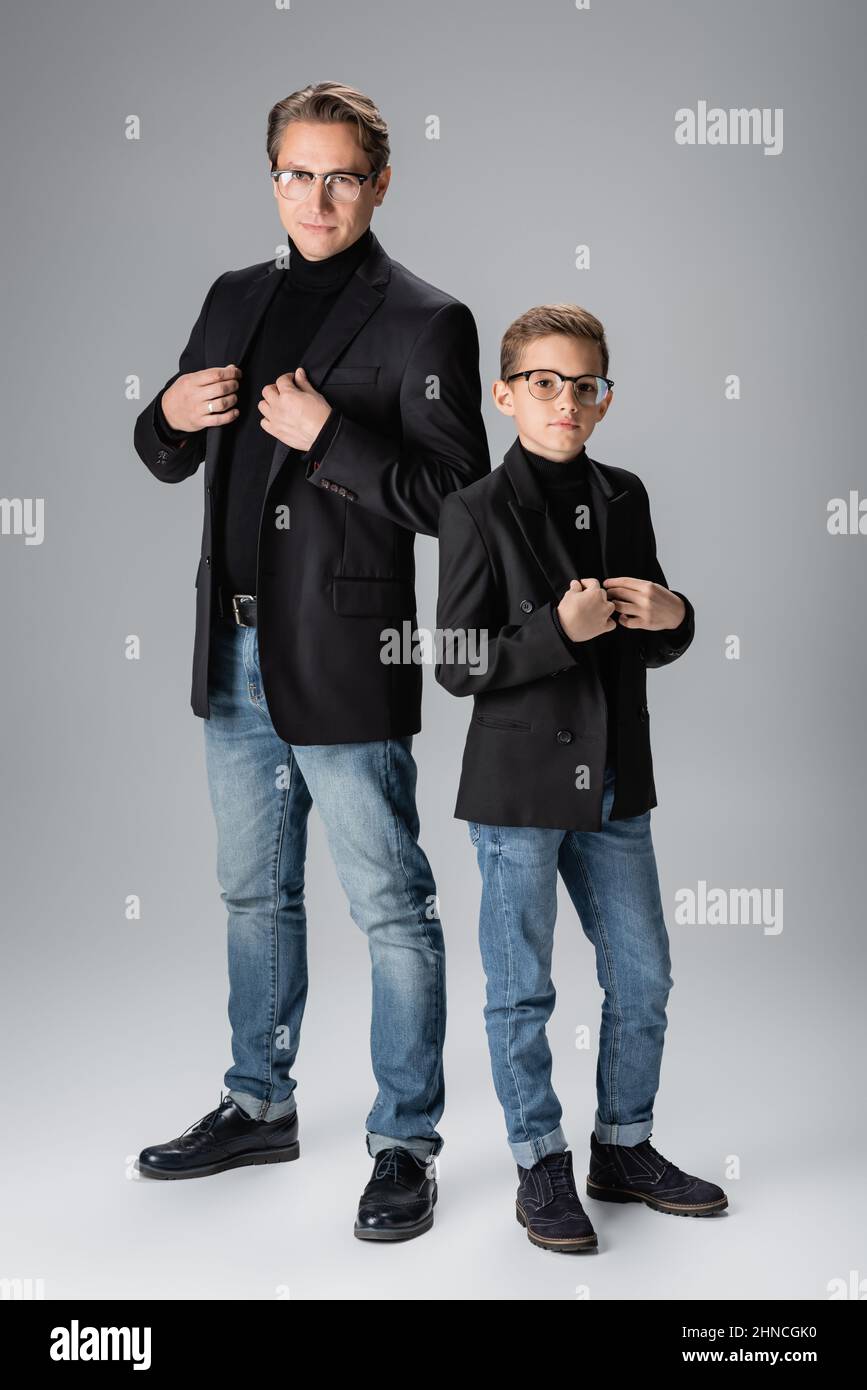 Full length of trendy dad and boy posing on grey background Stock Photo ...