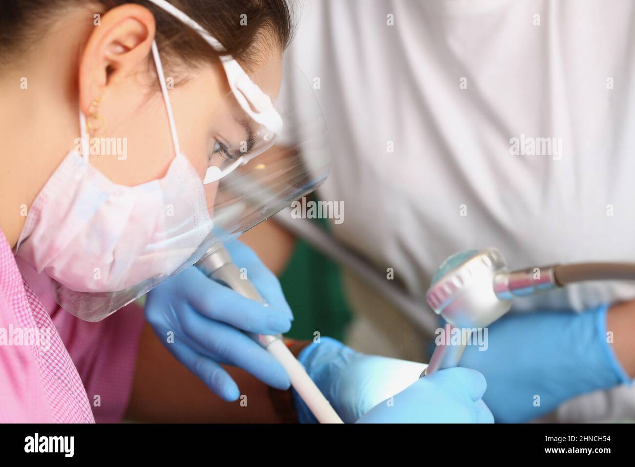 Woman dentist cure patients teeth on appointment, whitening procedure ...