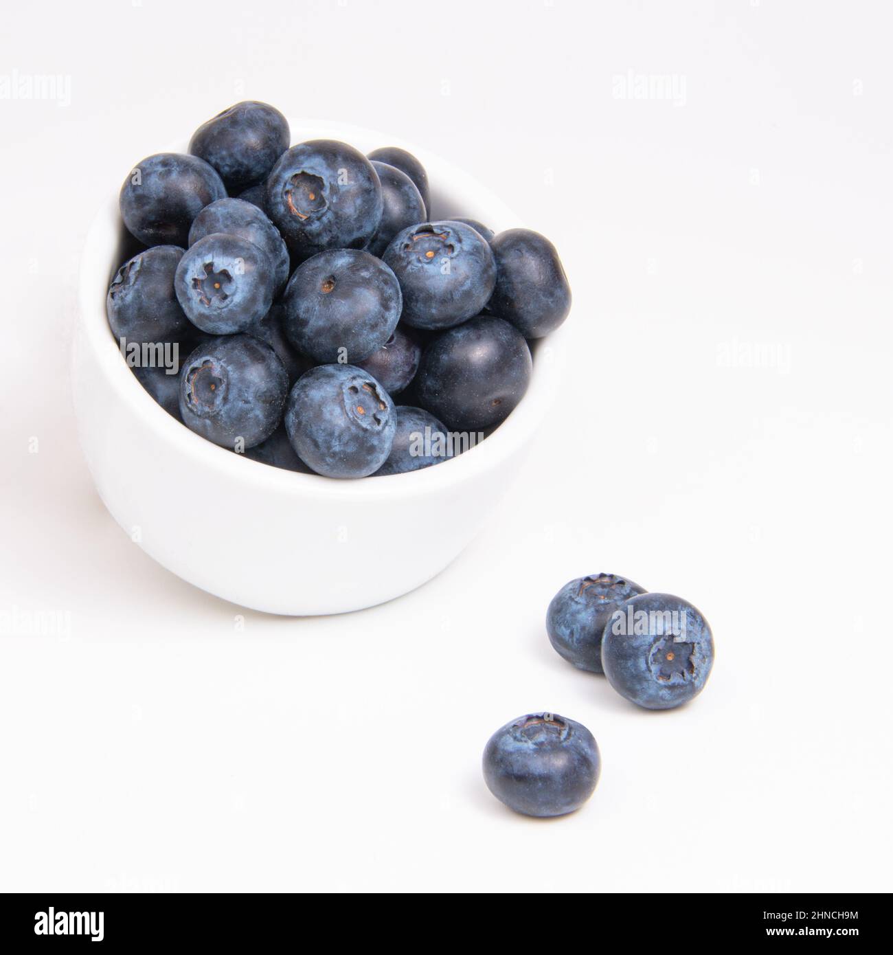 Fresh blueberry in white dish on the white background Stock Photo - Alamy