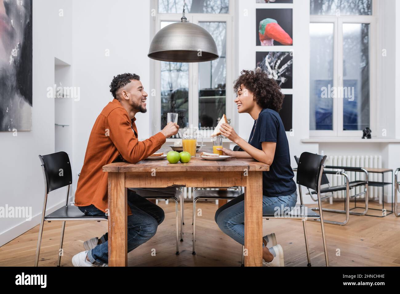 happy african american woman holding sandwich and having lunch with ...